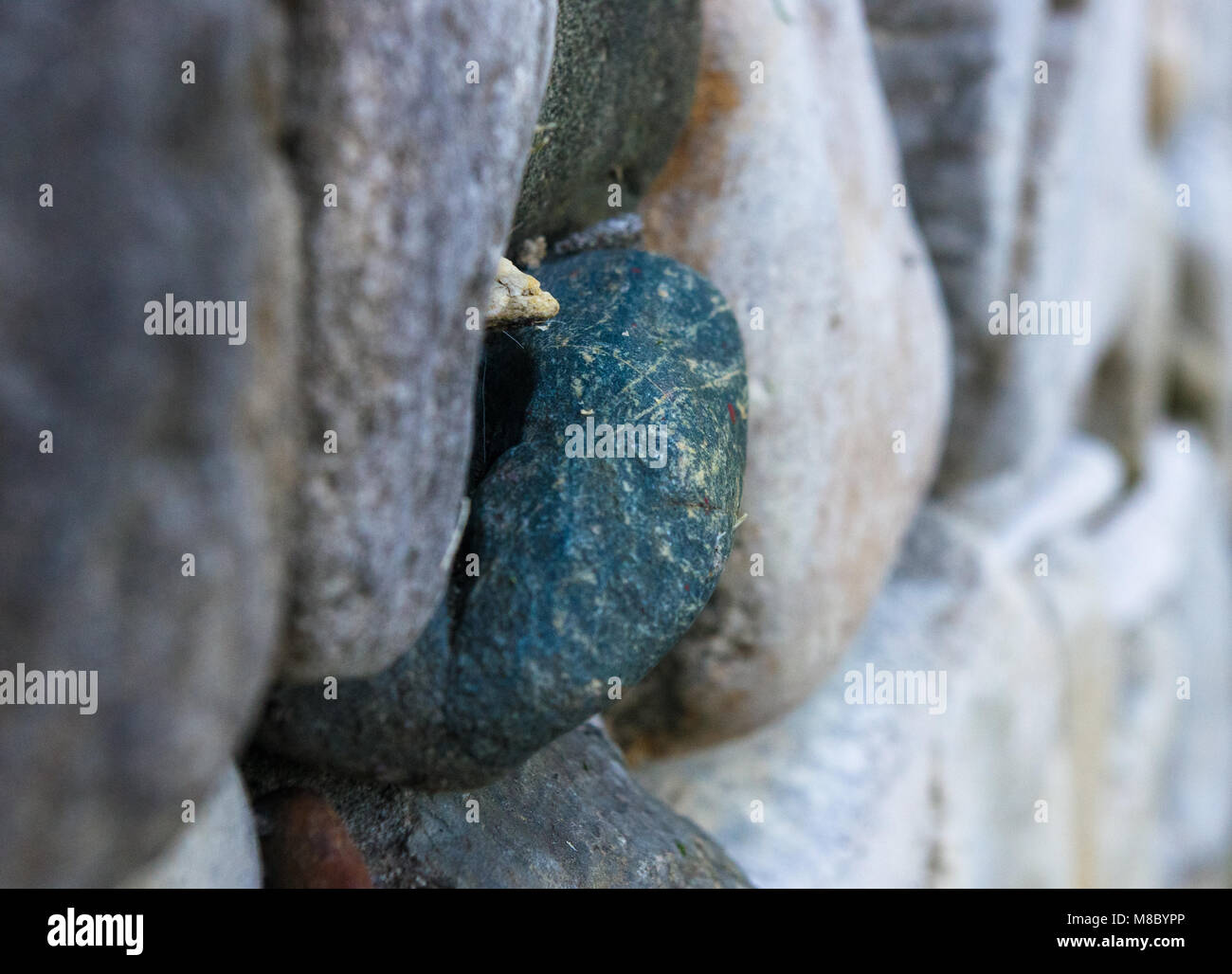 beautiful sea stones in the masonry of the wall of boulders, close-up ...