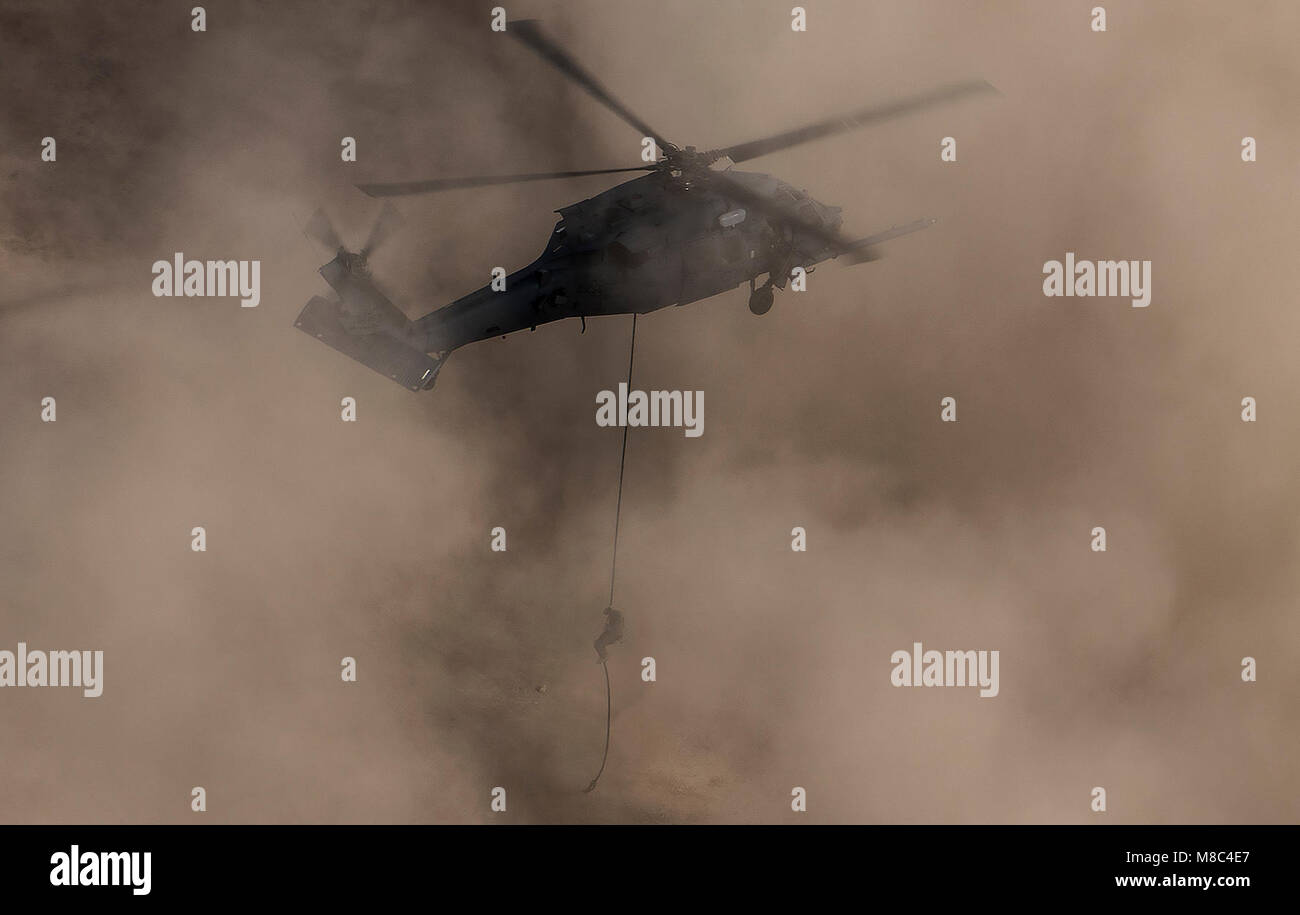 A U.S. Air Force pararescueman rappels out of an HH-60G Pave Hawk ...