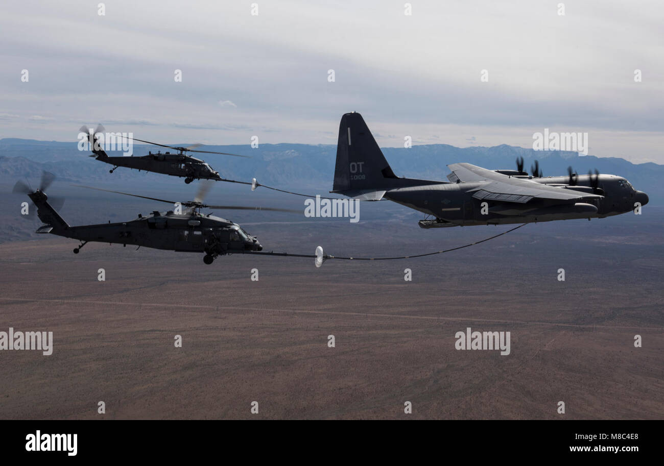 A pair of HH-60 Pave Hawk helicopters receive fuel from a HC-130J ...