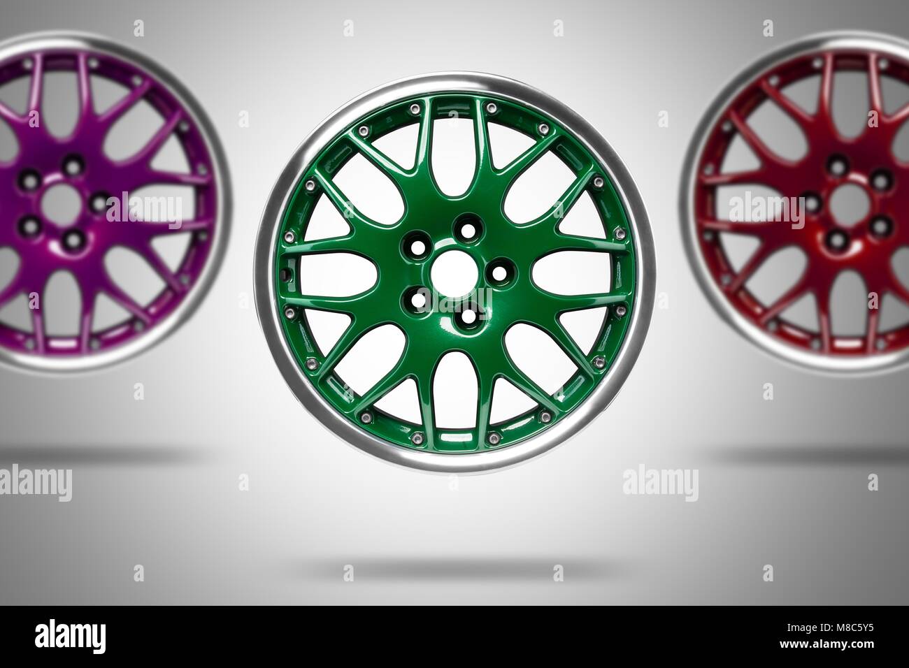 Colorful alloys rims floating in the air at grey background Stock Photo ...