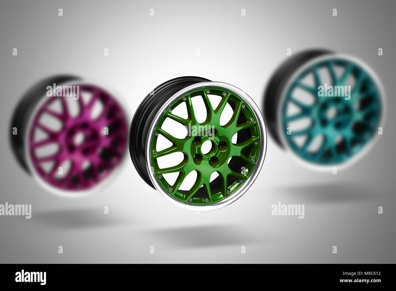 Colorful alloys rims floating in the air at grey background Stock Photo ...