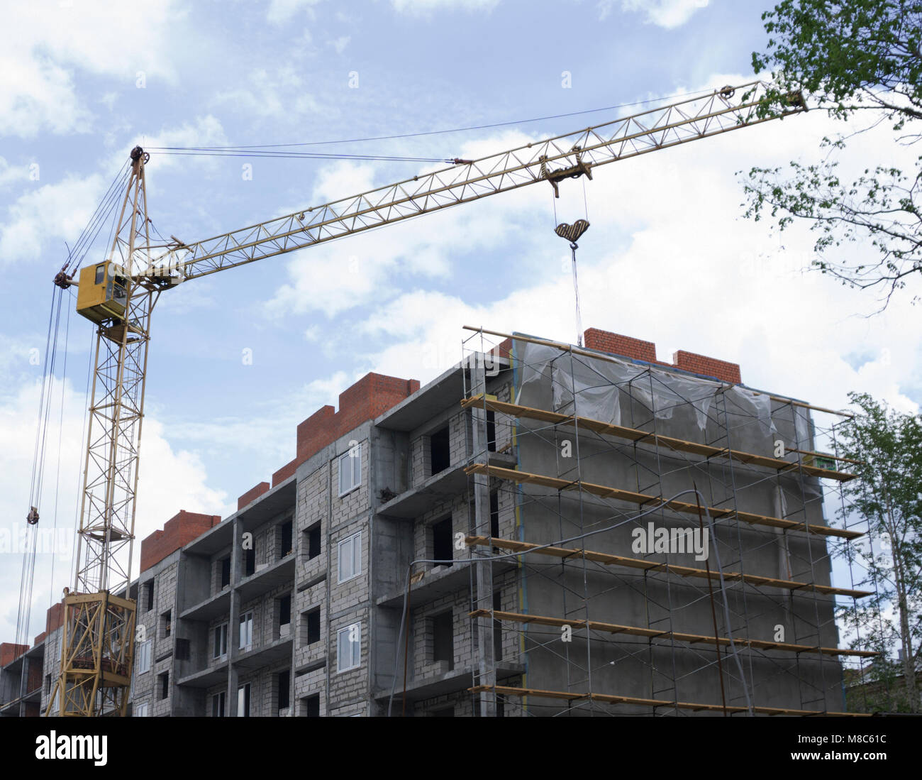 Construction site. Construction cranes and high-rise building under ...