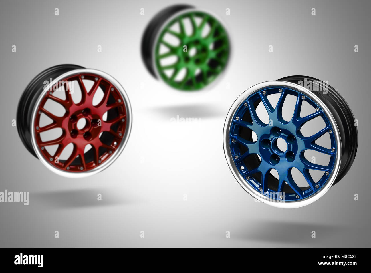 Colorful alloys rims floating in the air at grey background Stock Photo ...