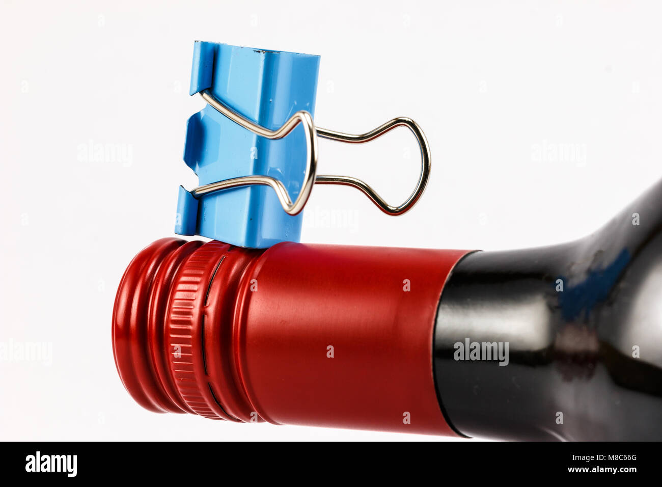 binder clip on top of Wine bottle on white background Stock Photo - Alamy