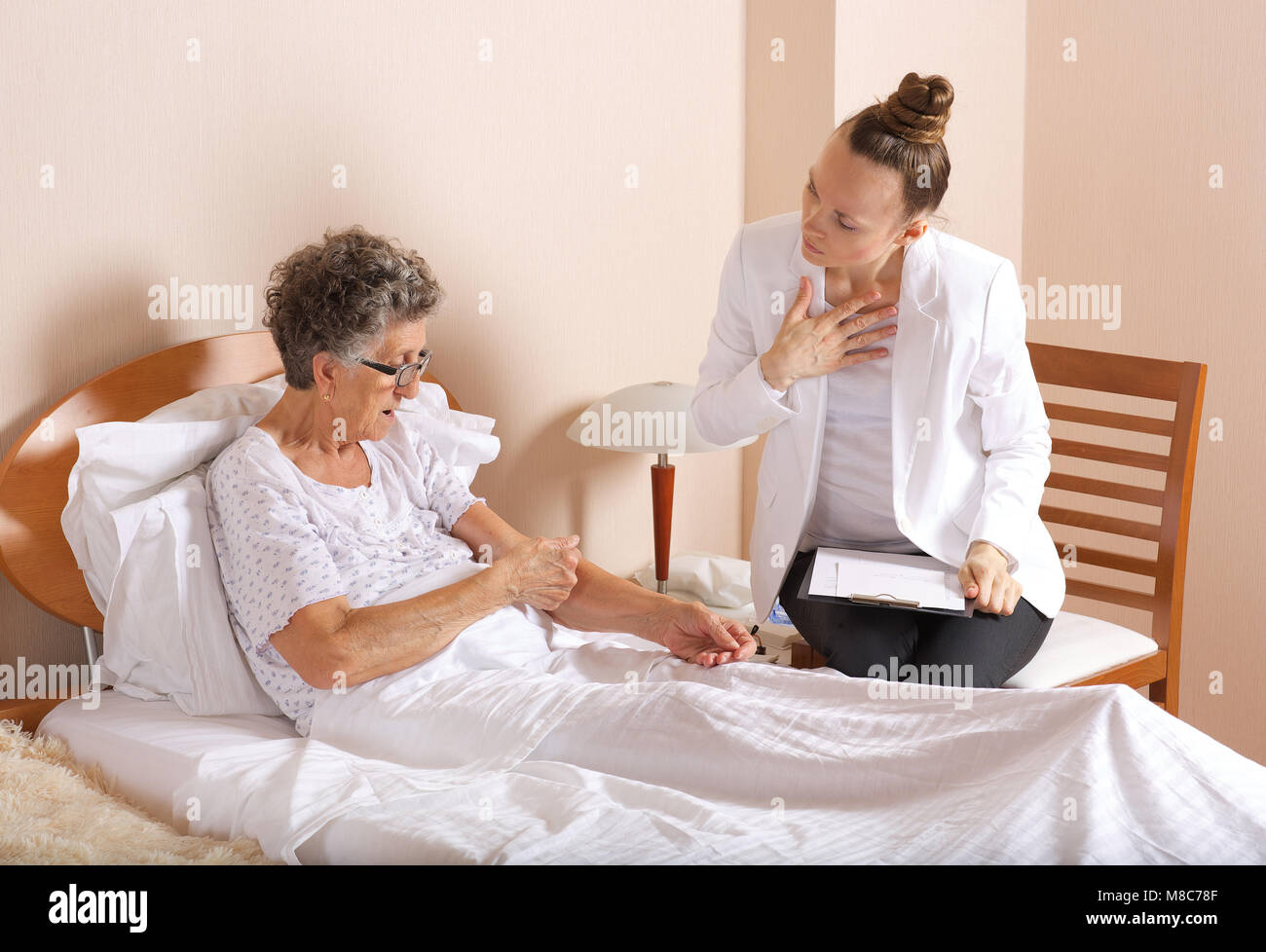 Old woman with senior social work assistant Stock Photo - Alamy
