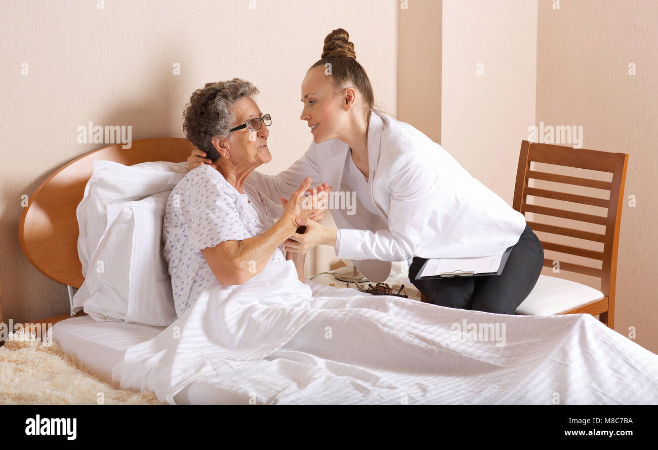Old woman with senior social work assistant Stock Photo - Alamy