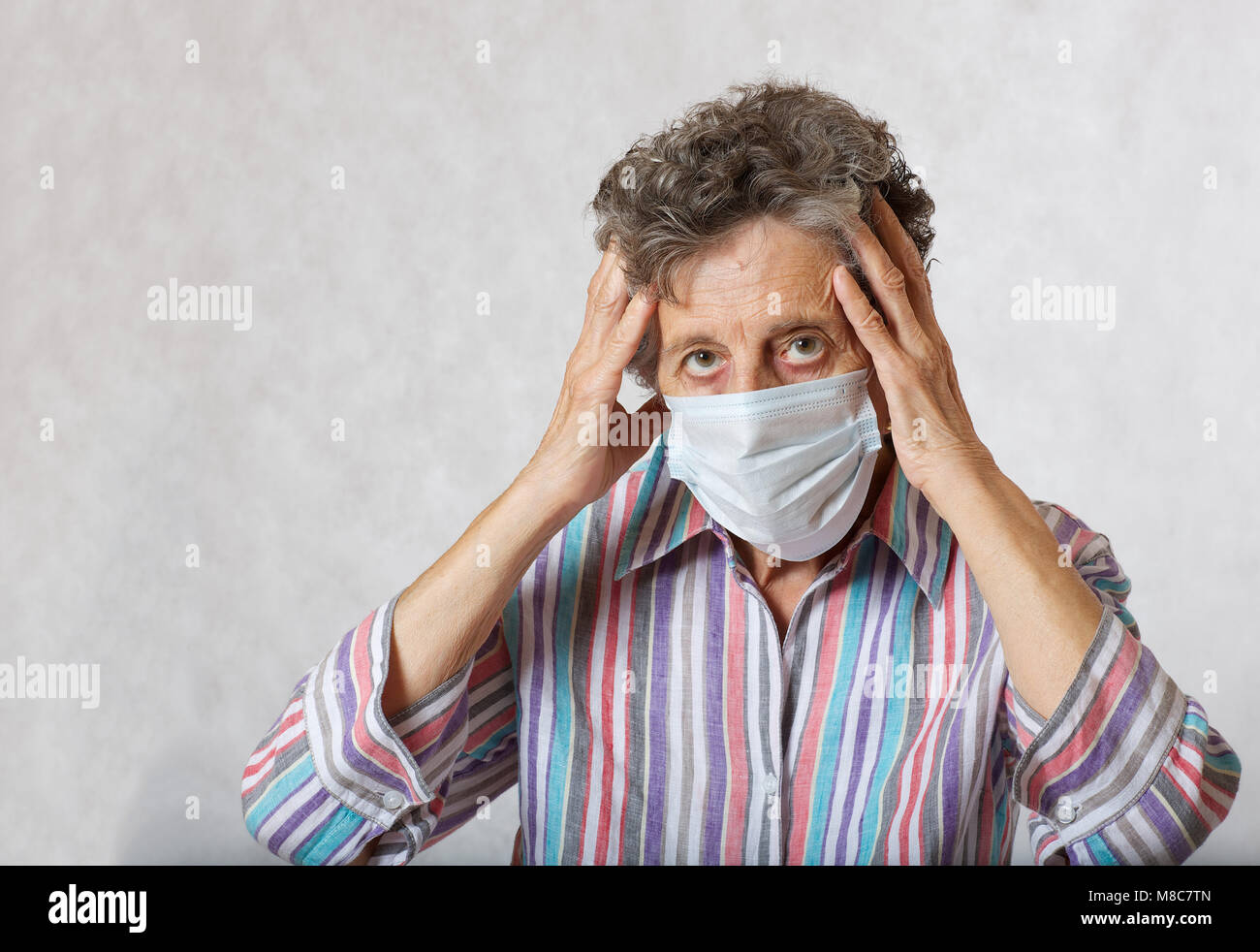 Old woman between 70 and 80 years old dressed a mask Stock Photo - Alamy