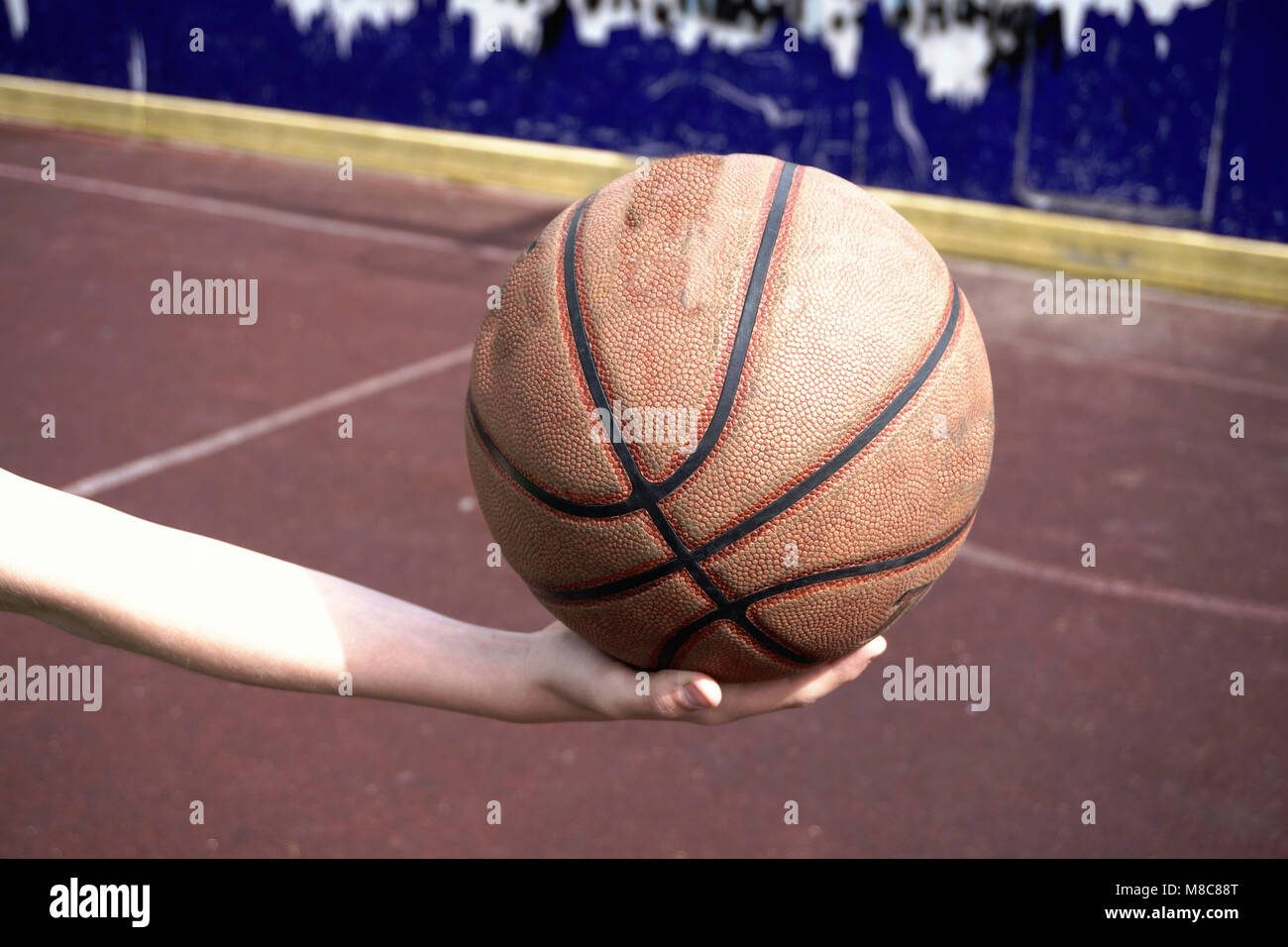 Basketball ball in hand Stock Photo - Alamy