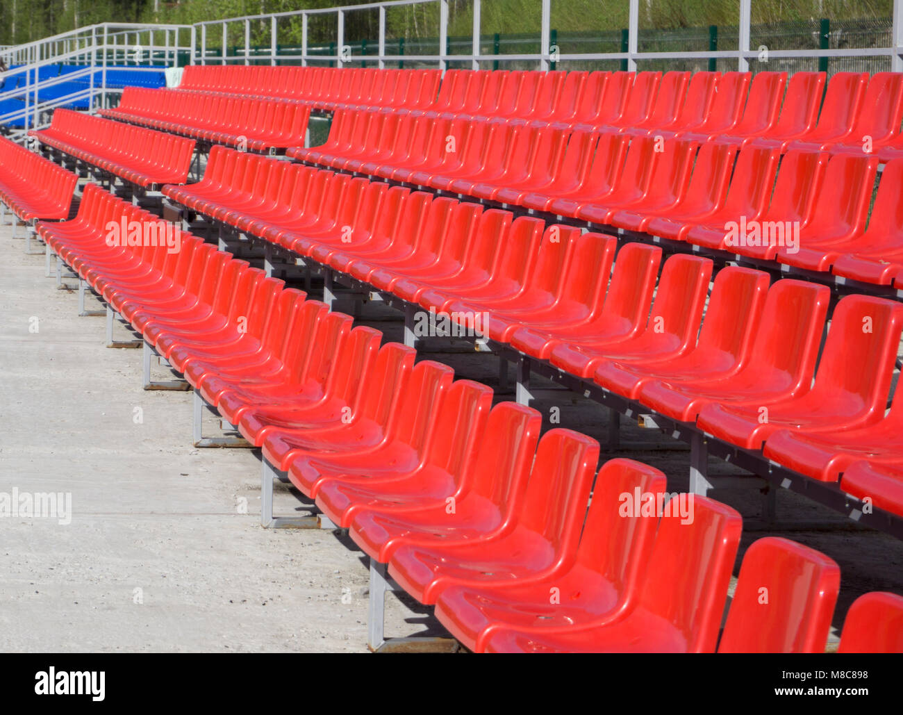 blue, red, white rows of seats on the stadium Stock Photo - Alamy
