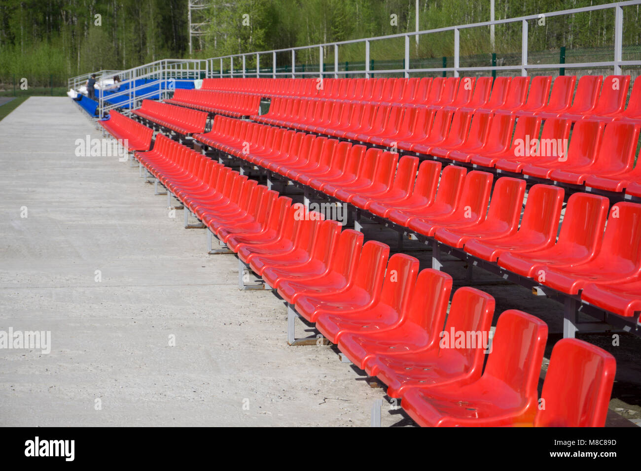 blue, red, white rows of seats on the stadium Stock Photo - Alamy