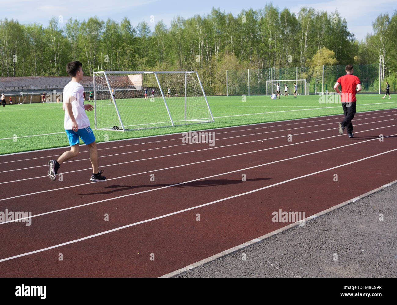 Young man in doing exercise. at the stadium Stock Photo - Alamy