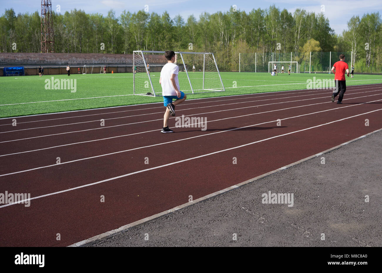 Young man in doing exercise. at the stadium Stock Photo - Alamy