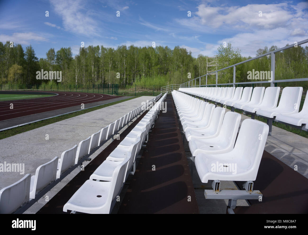 blue, red, white rows of seats on the stadium Stock Photo - Alamy