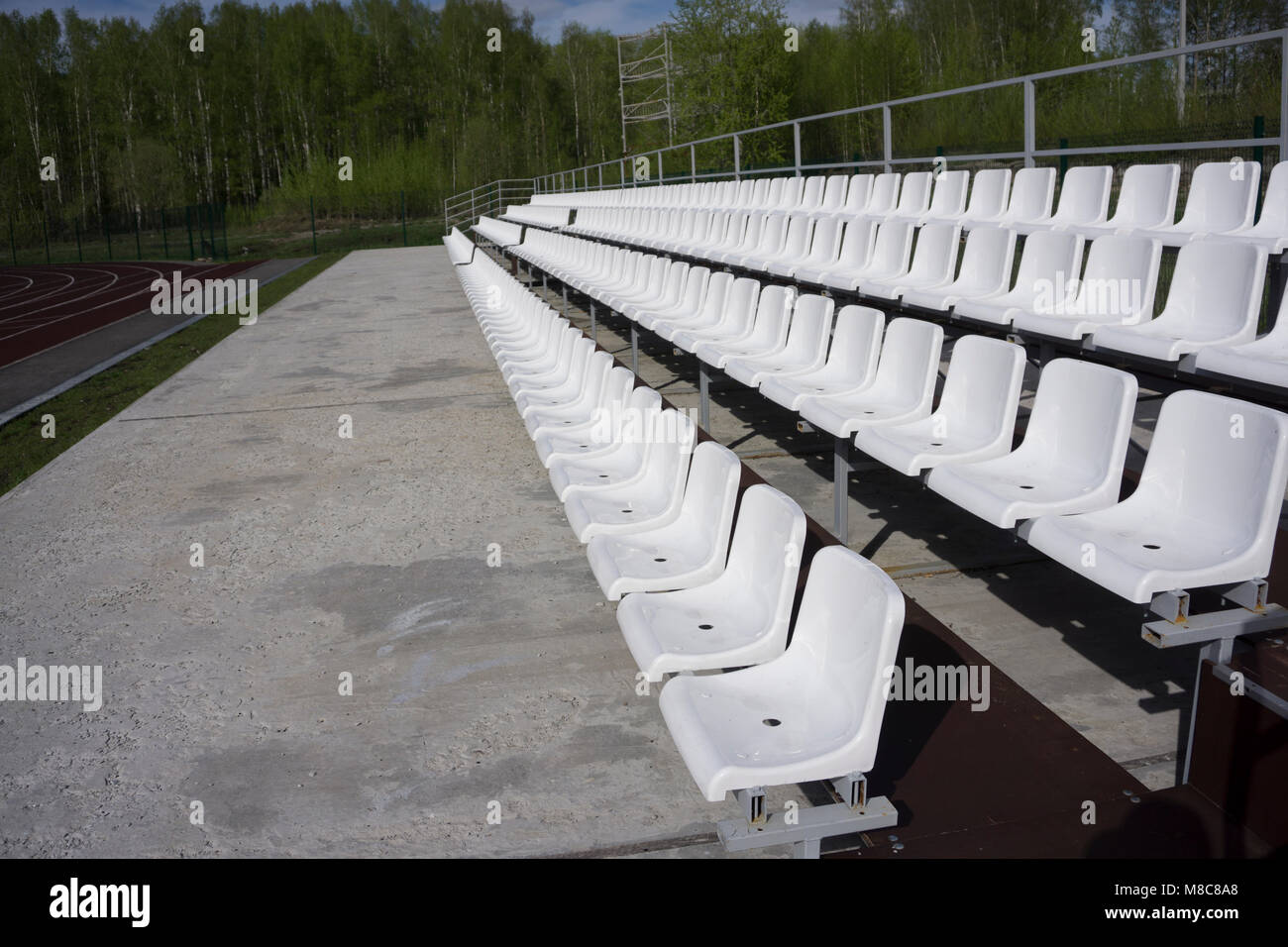 blue, red, white rows of seats on the stadium Stock Photo - Alamy