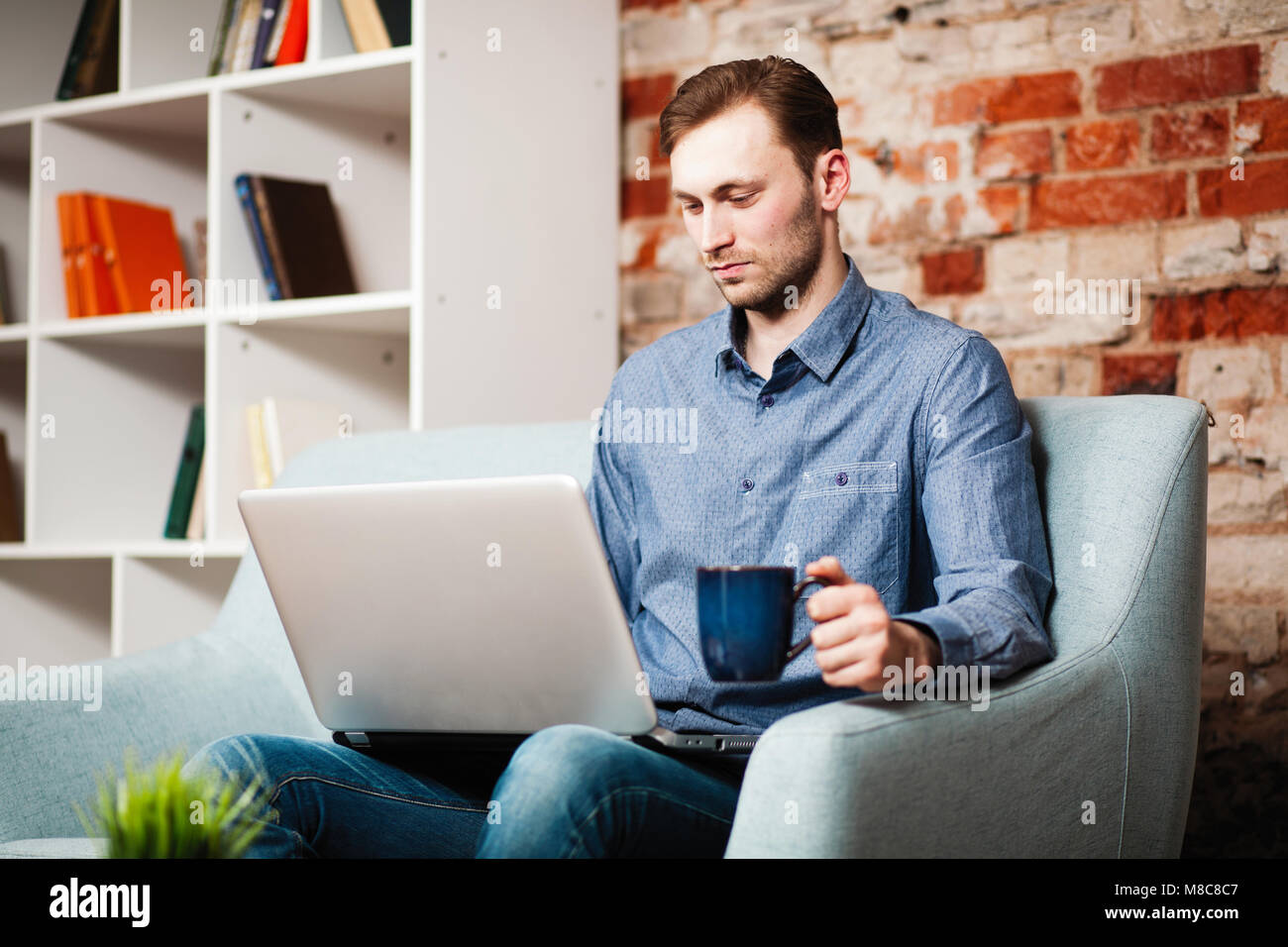 Young man with a laptop Stock Photo - Alamy