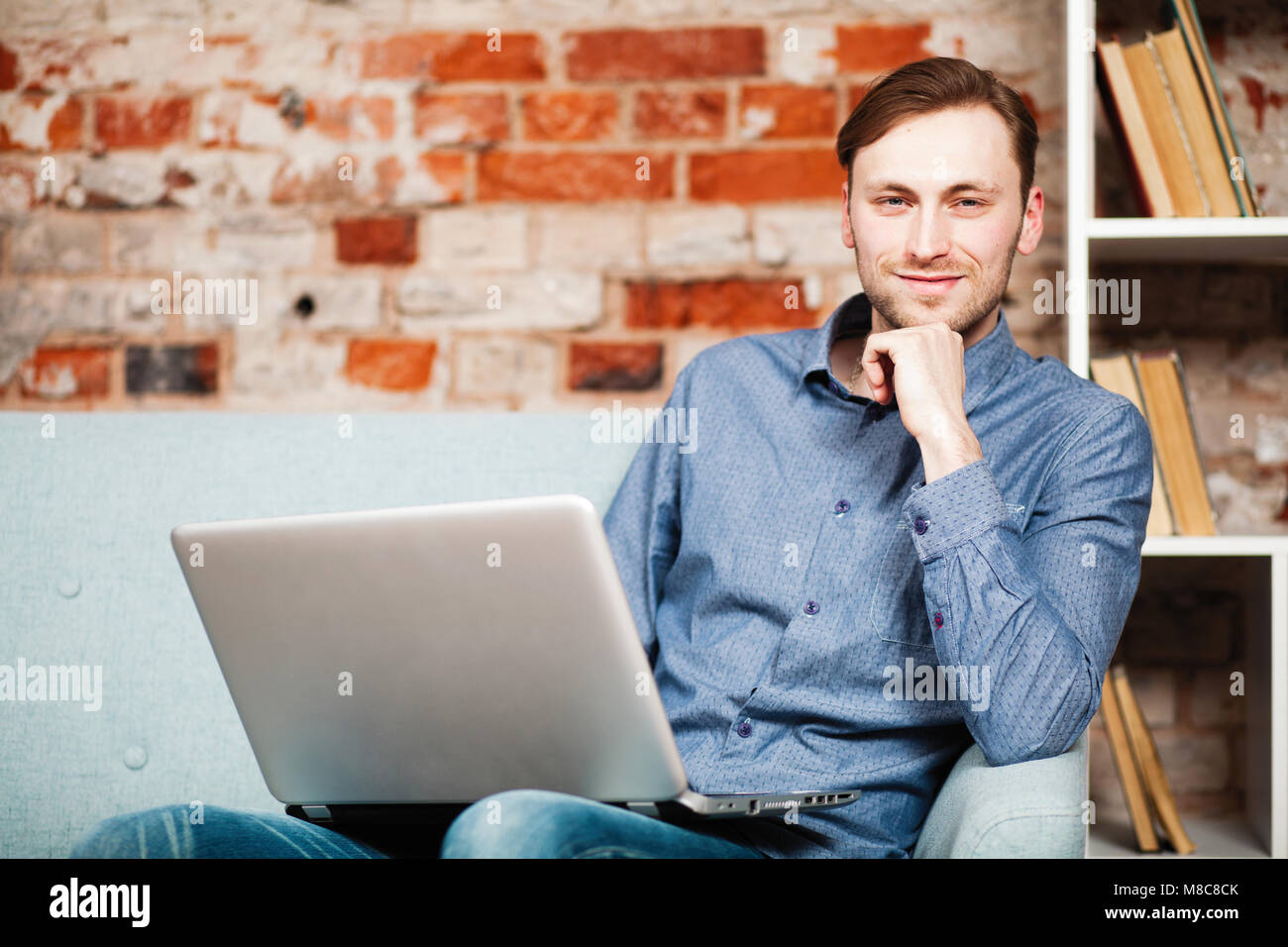 Young man with a laptop Stock Photo - Alamy