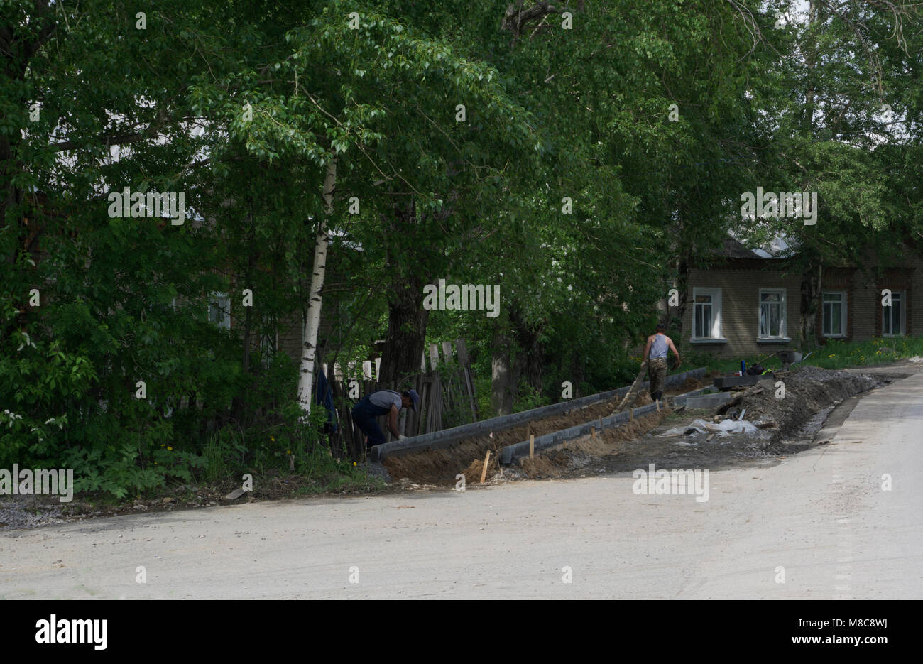 Concrete curb installation. String line level guide is stretched ...