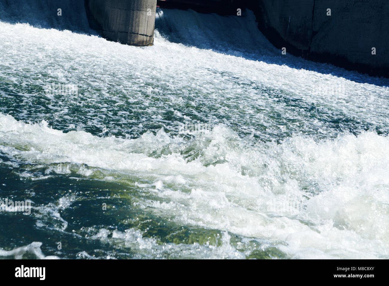 Beautiful powerful rapid steam of the mountain river flows between ...