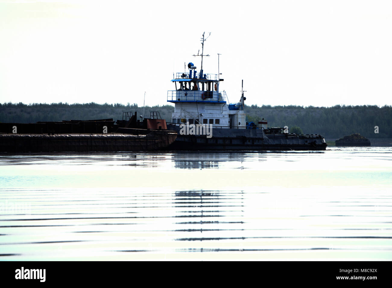 the Tug boat floats on the river Stock Photo - Alamy