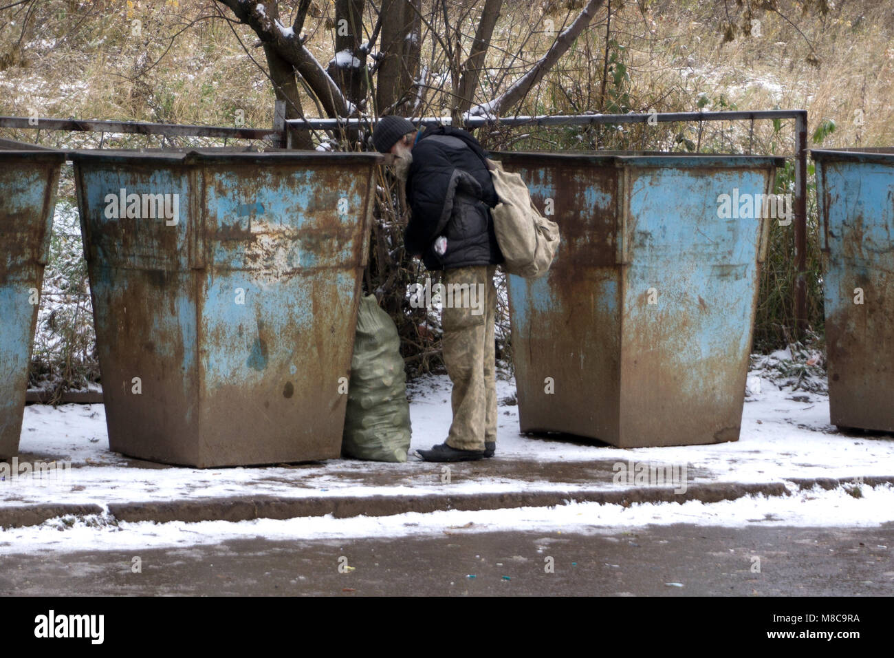 Poor rummaging in the garbage hi-res stock photography and images - Alamy