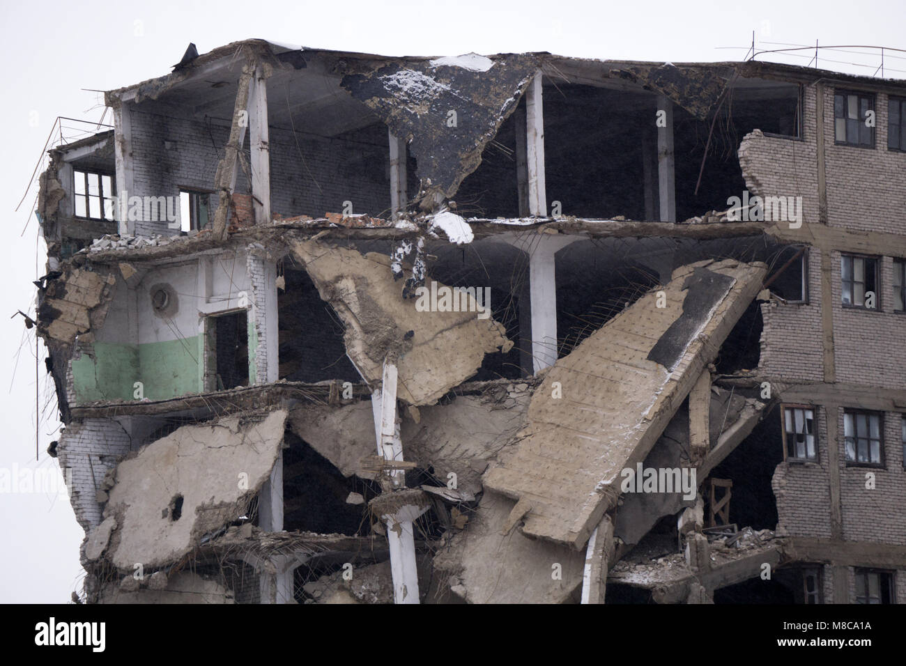 Room sections in the half-destroyed building. The collapse of the wall ...