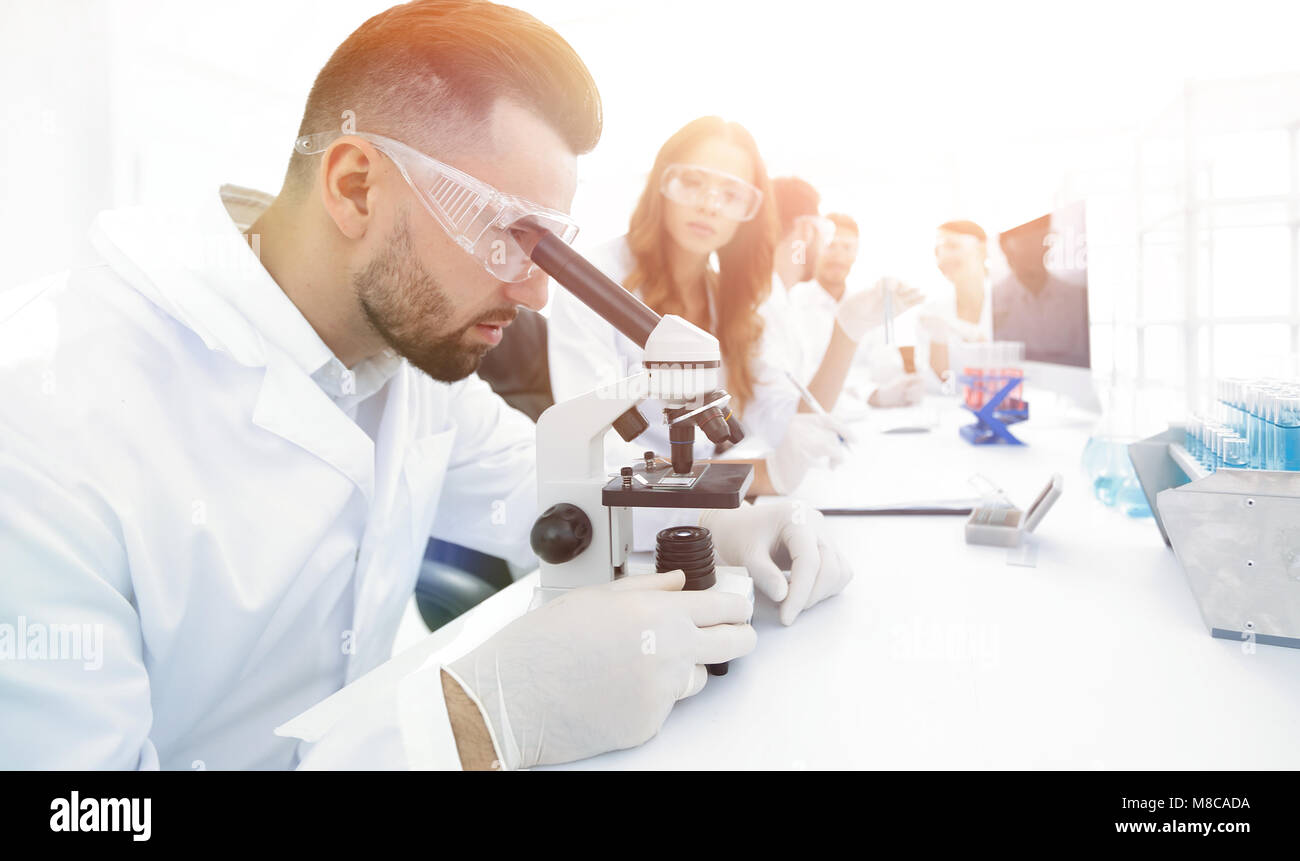 researcher looking into a microscope in a modern laboratory Stock Photo ...
