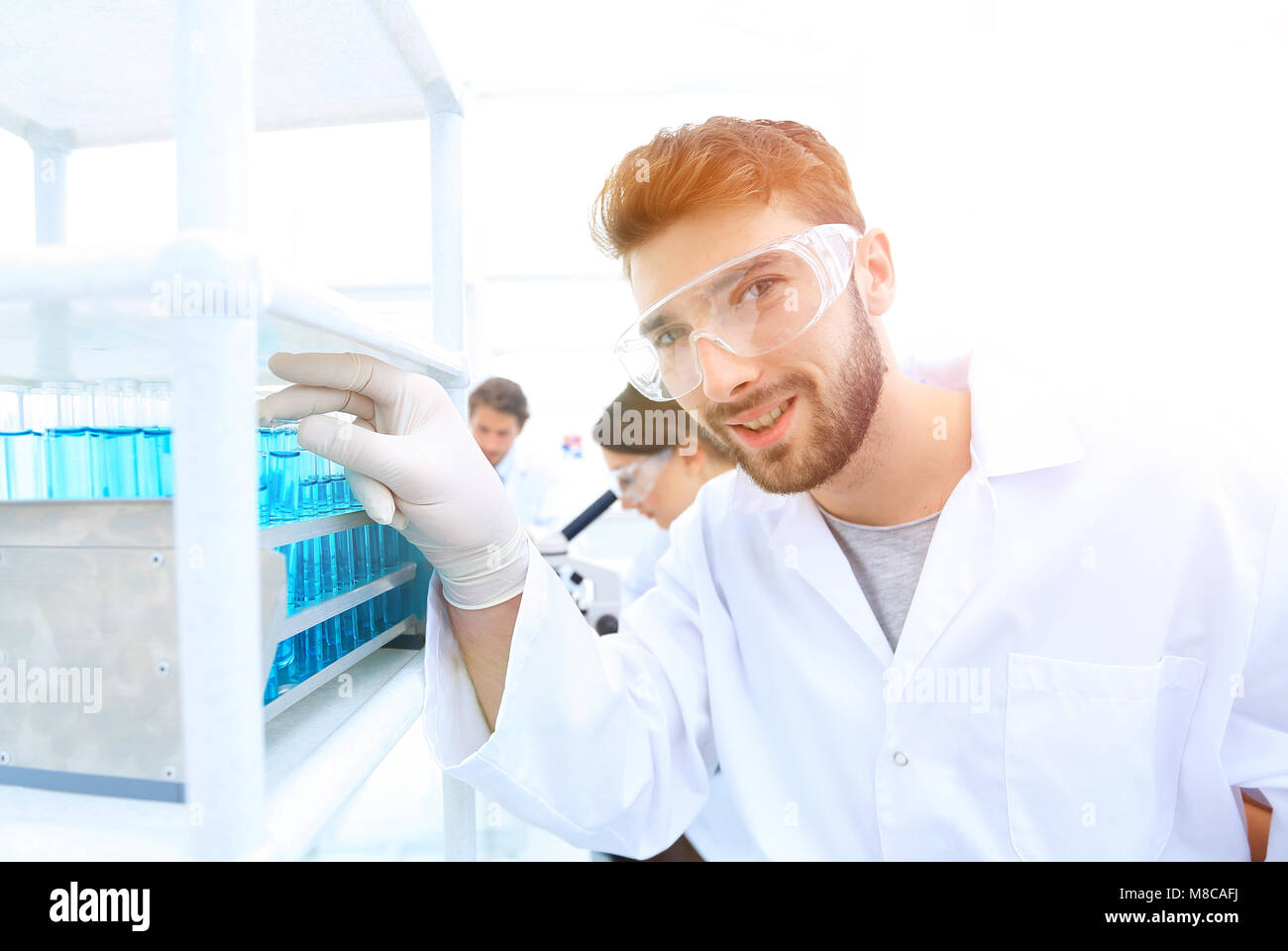 A young man doing an experiment in a chemical laboratory Stock Photo ...