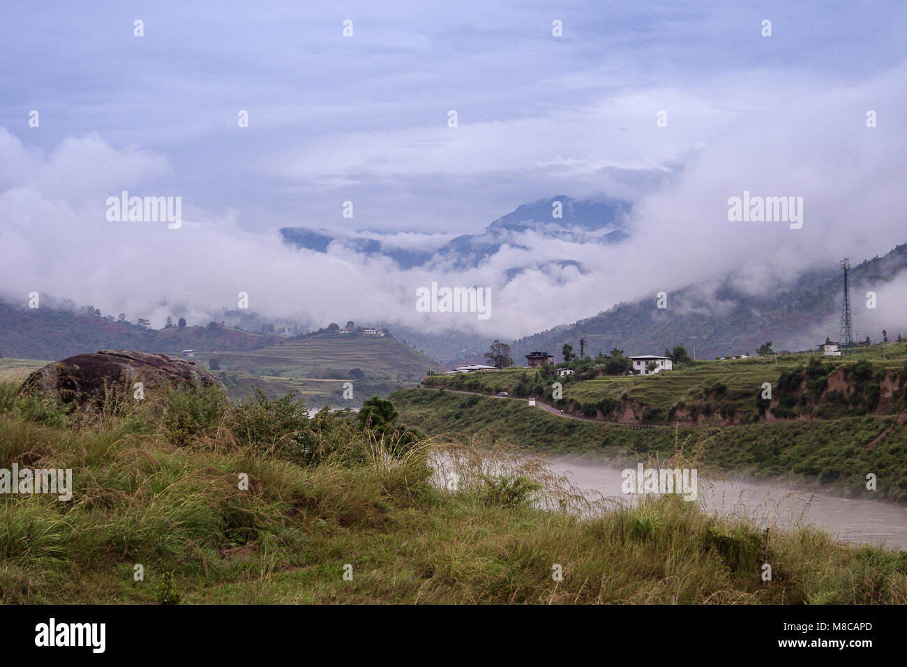 The river Sankosh (Puna Tsang Chu) in early morning mist. Low clouds ...