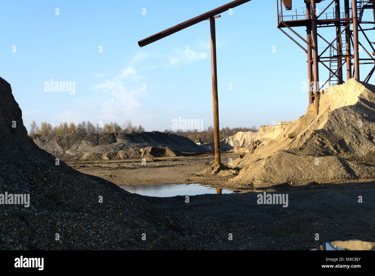 Sand extraction in the quarry through pipes Stock Photo - Alamy