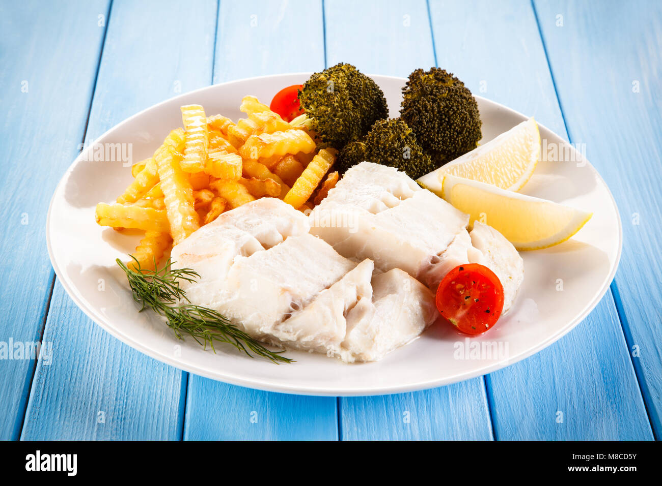Fish dish - fried fish fillet and vegetables Stock Photo - Alamy