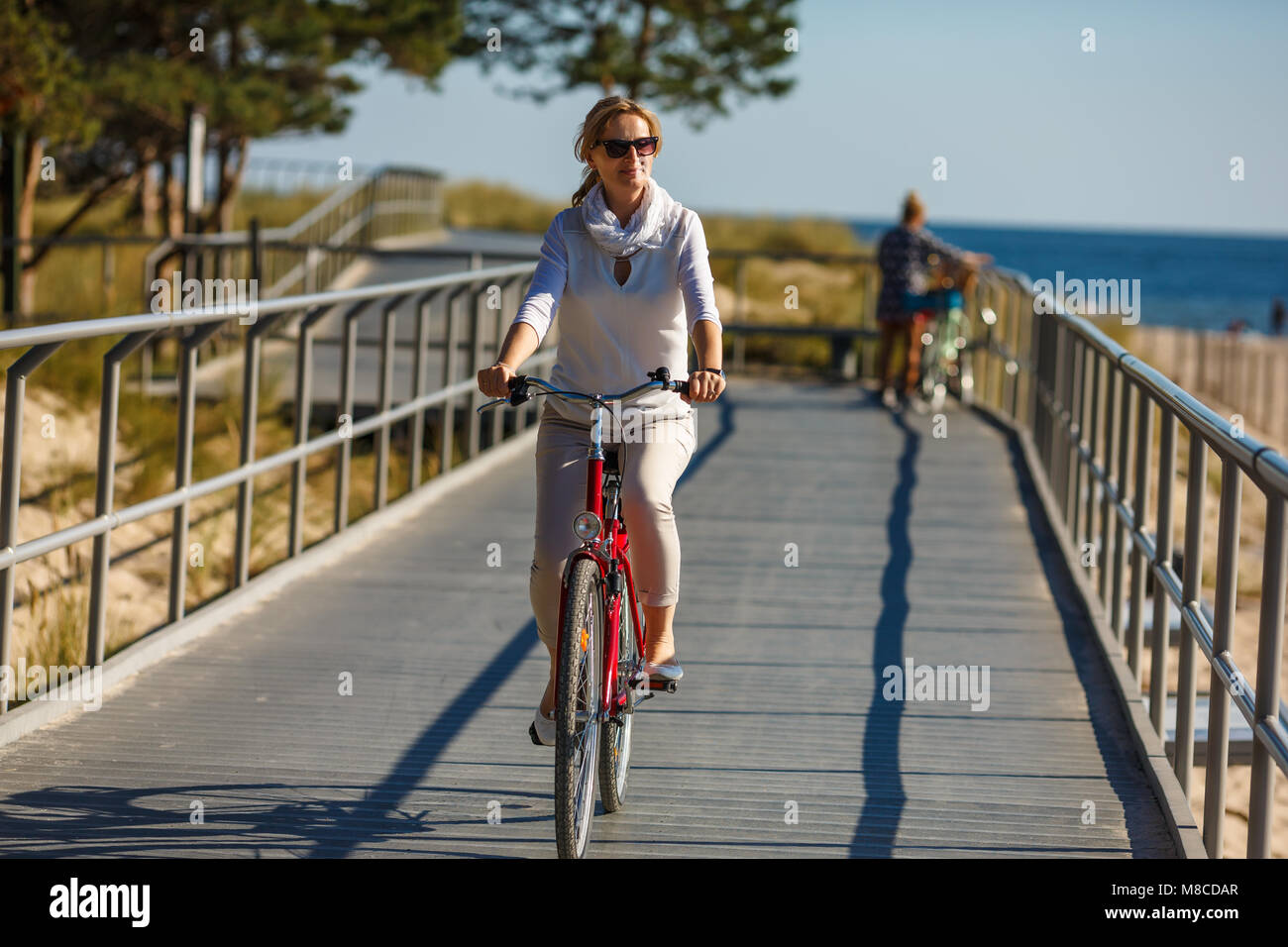 Woman riding bike outdoor Stock Photo - Alamy