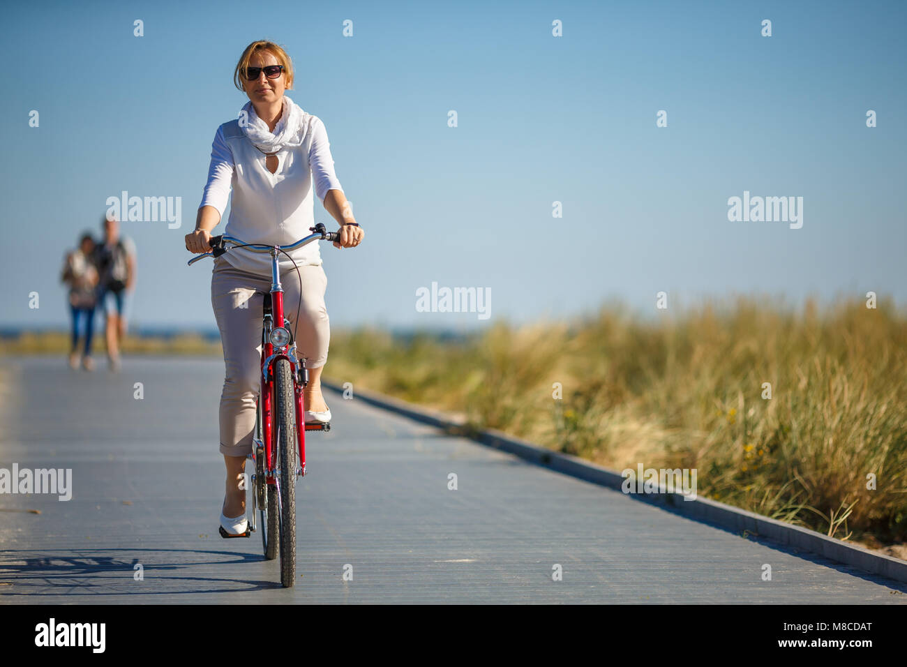 Woman riding bike outdoor Stock Photo - Alamy