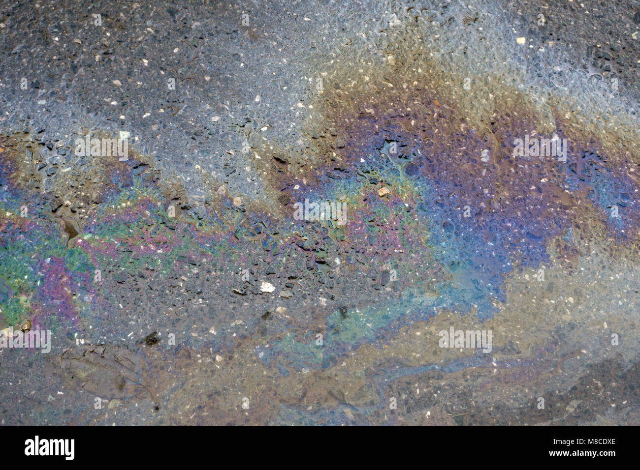 Oil slick on the asphalt road background Stock Photo - Alamy