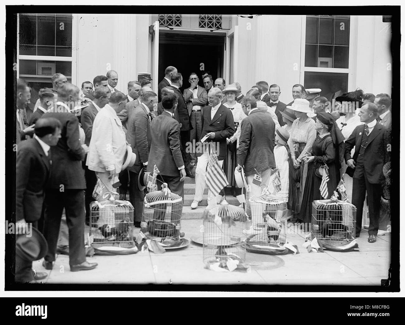 A historical photograph of Alabama citizens presenting roosters to the ...