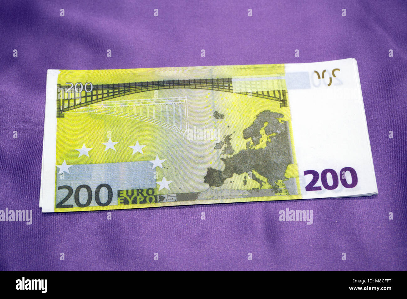 200 Euro banknotes on a purple background Stock Photo - Alamy