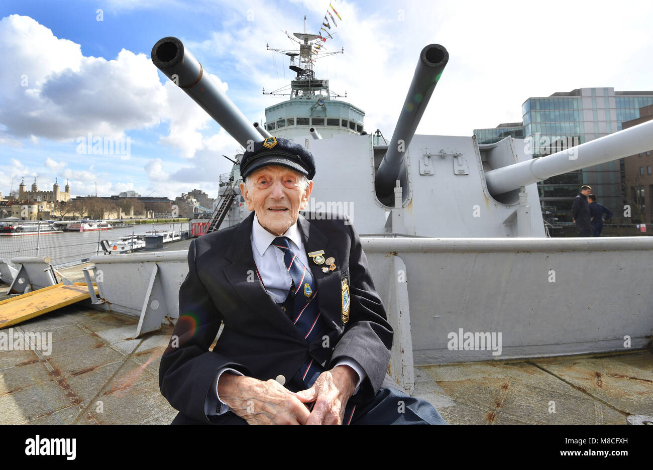 John Harrison aged 104, sits on the foredeck of HMS Belfast in front of ...
