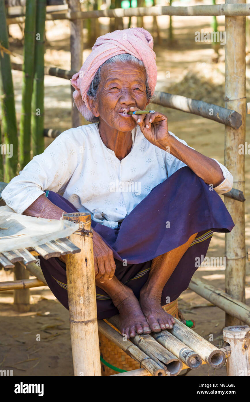 Old Burmese woman smoking cigar at Indein Village, Inle Lake, Shan ...