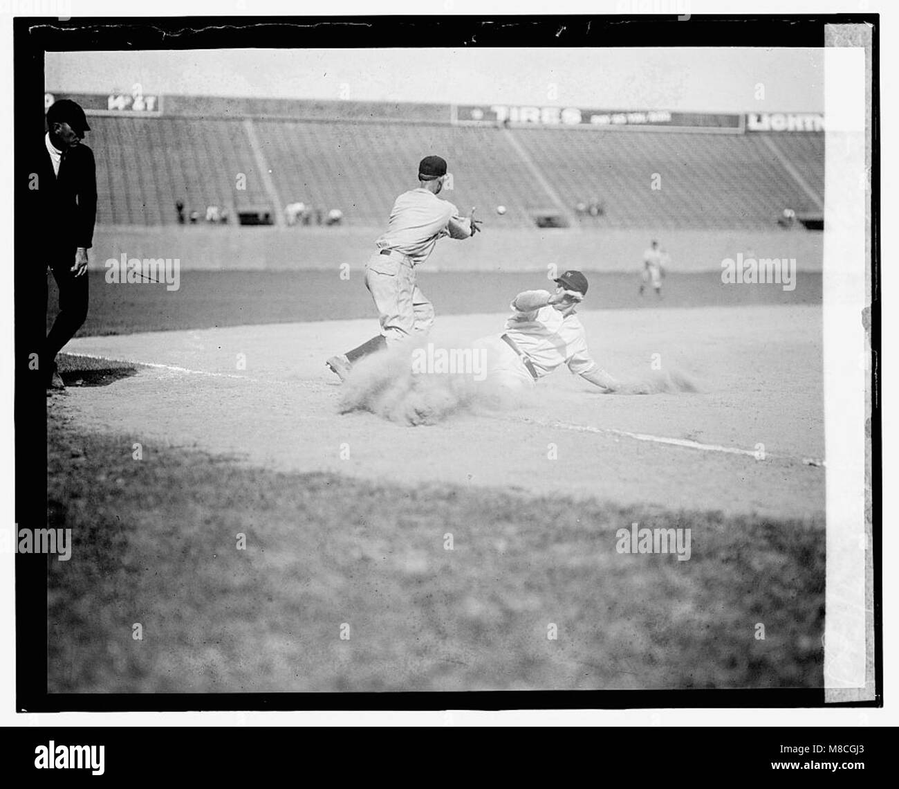 A photograph capturing Goslin safely reaching third base during a ...