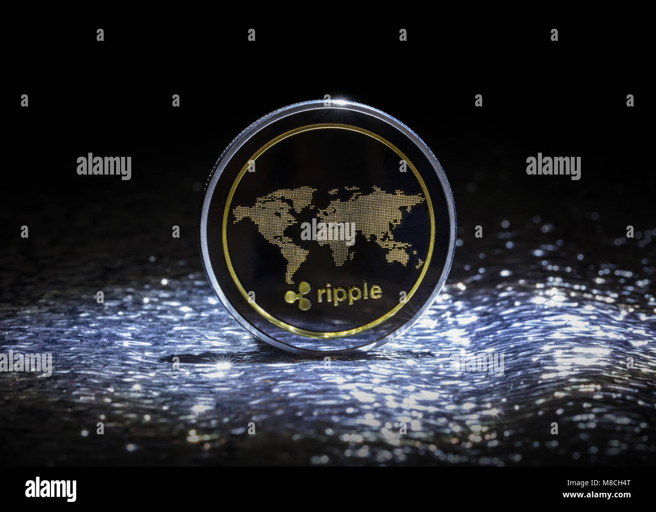 ripple crypto currency close-up on darkly shiny background Stock Photo ...