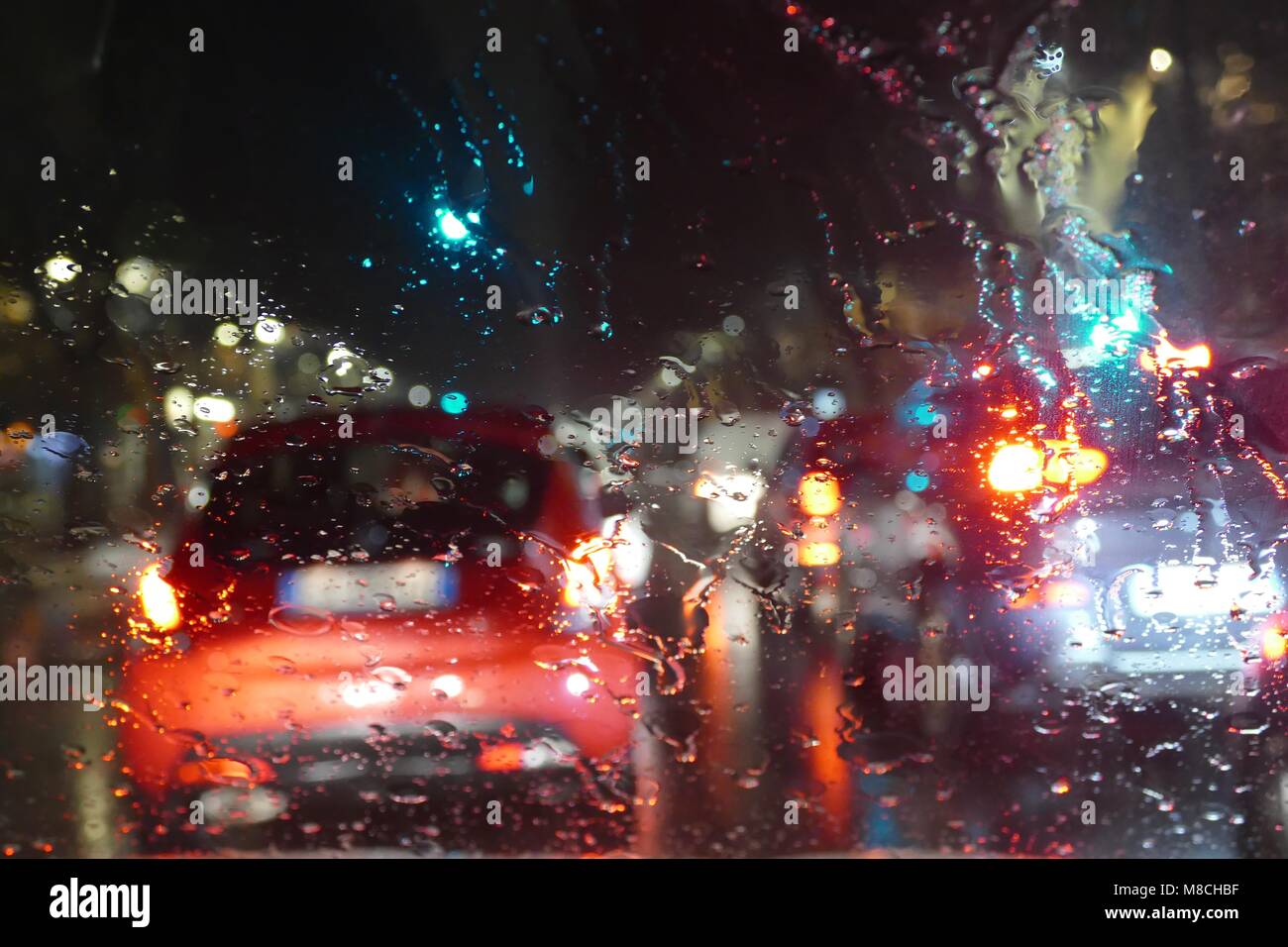 Road traffic in rainy night tunnel with cars and lights selective focus ...