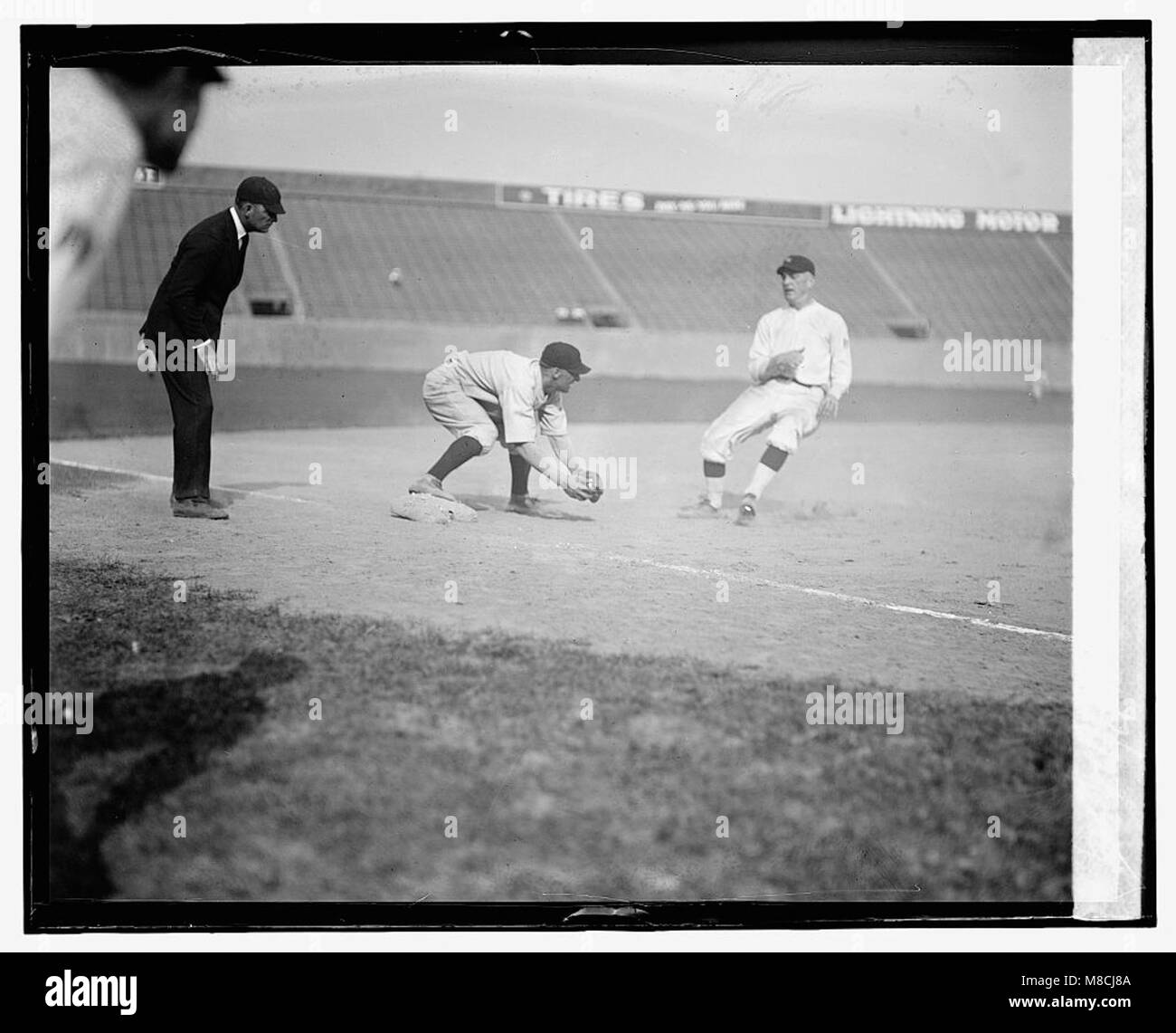 This image captures a moment in a baseball game, where a player is out ...