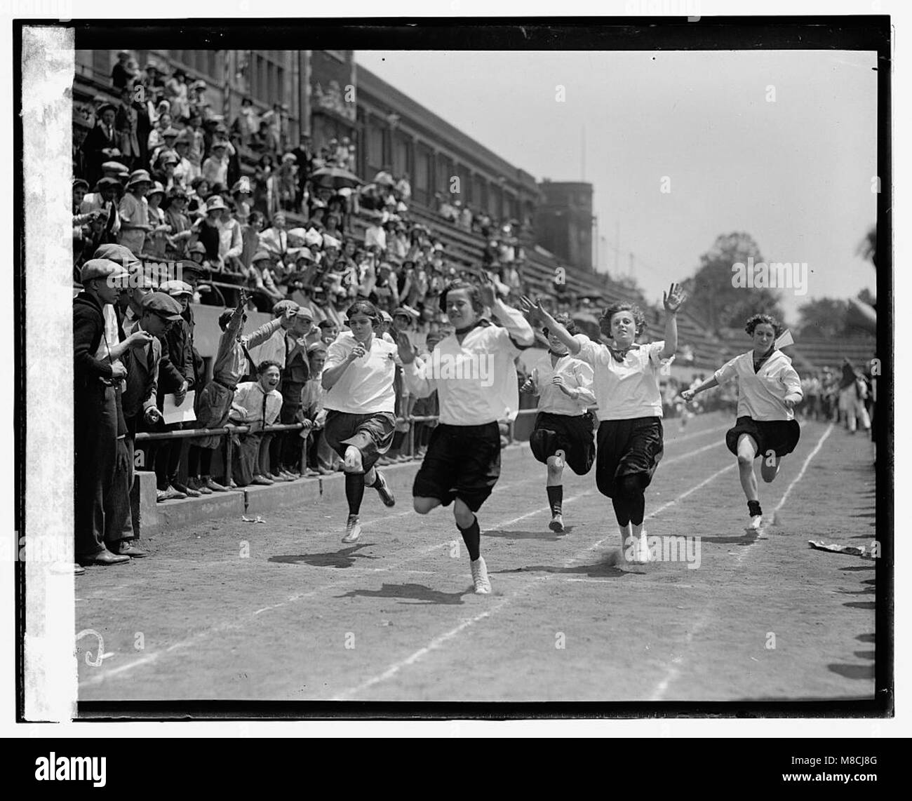 A junior high school track and field meet is depicted, showcasing young ...