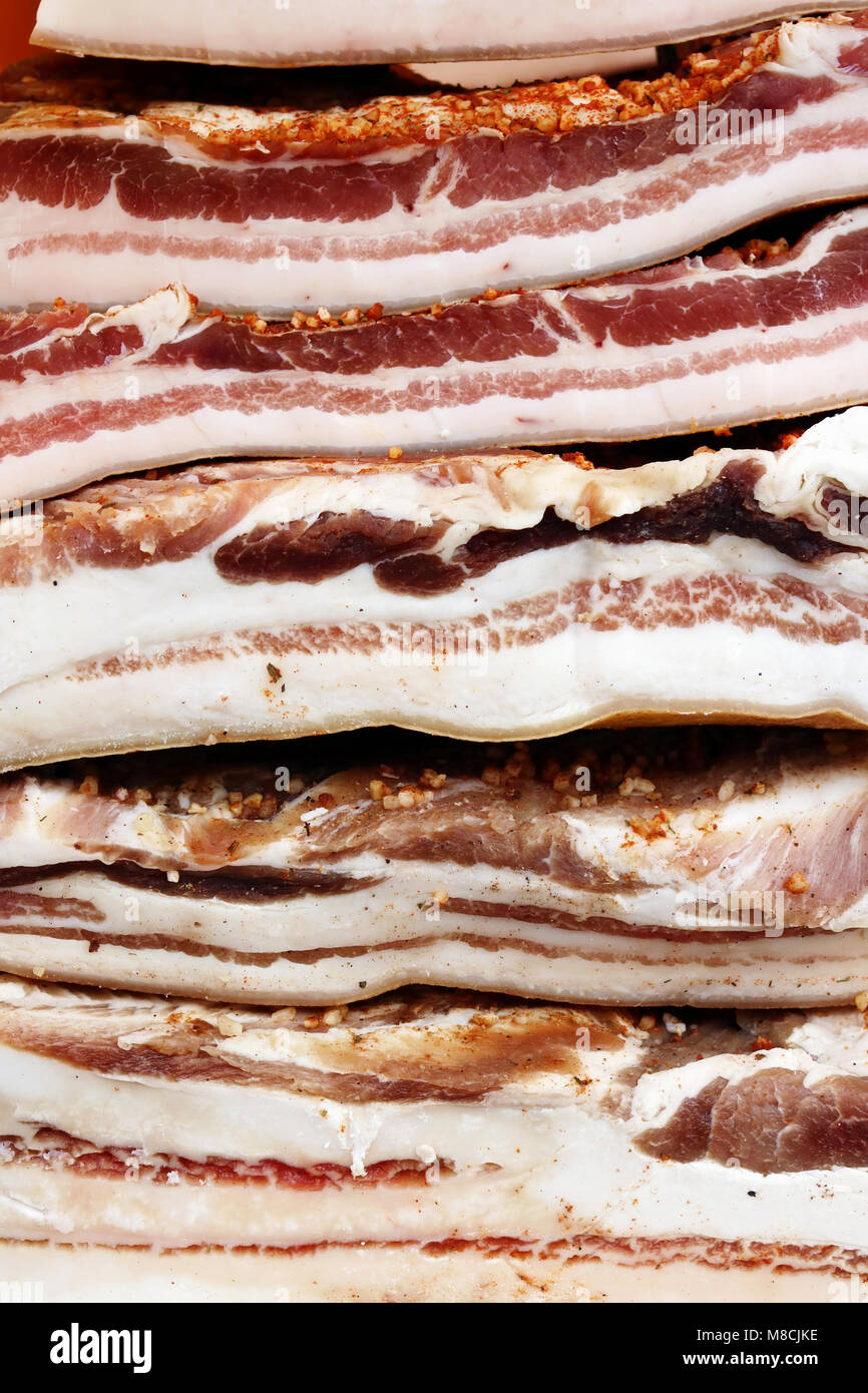 Cross sections of large pieces of smoked salted lard. Meat is prepared ...