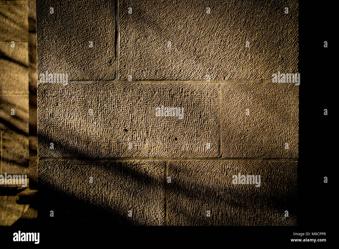 Evening shadows on a stone wall Stock Photo - Alamy