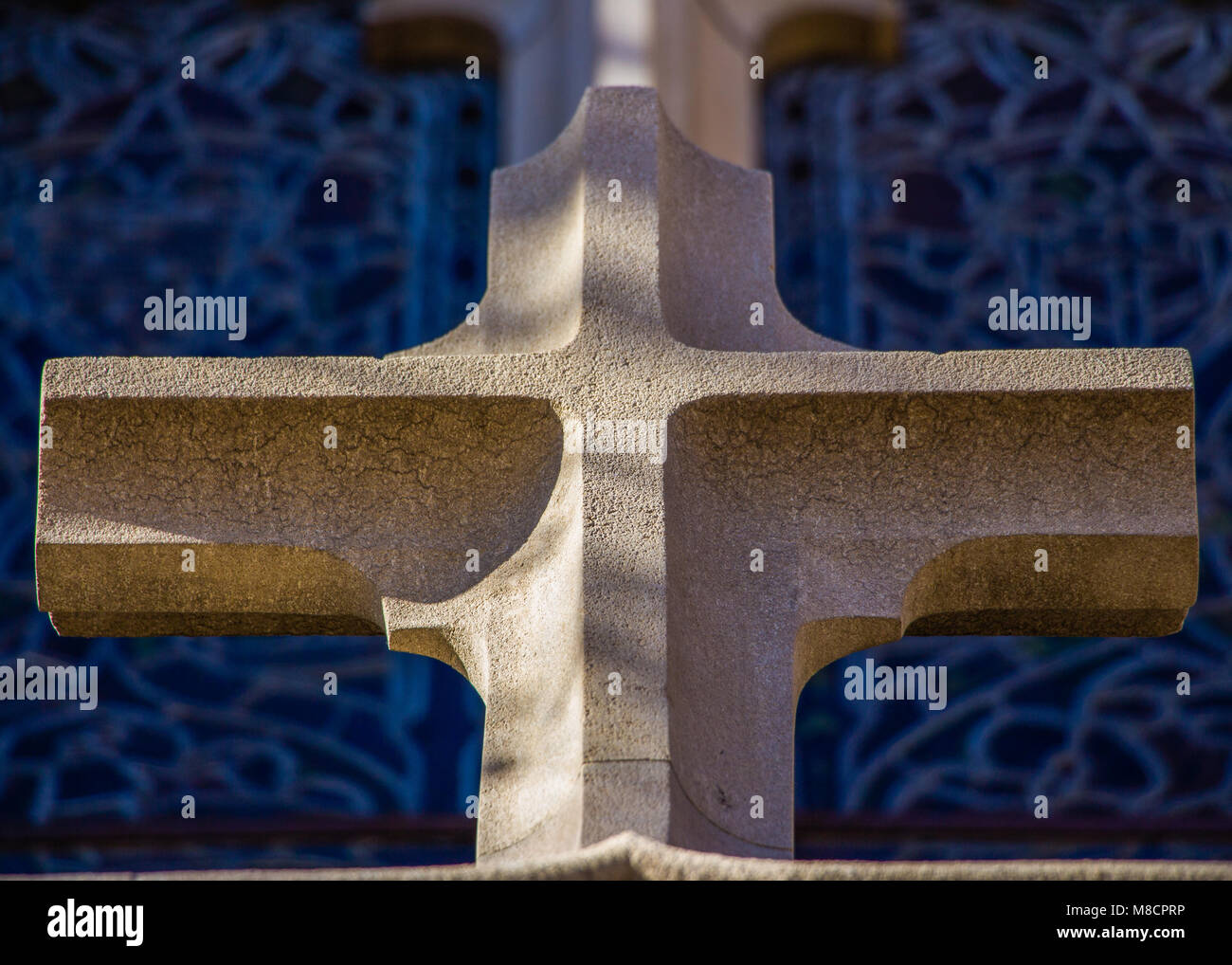 Exterior stone cross with stained glass background Stock Photo - Alamy