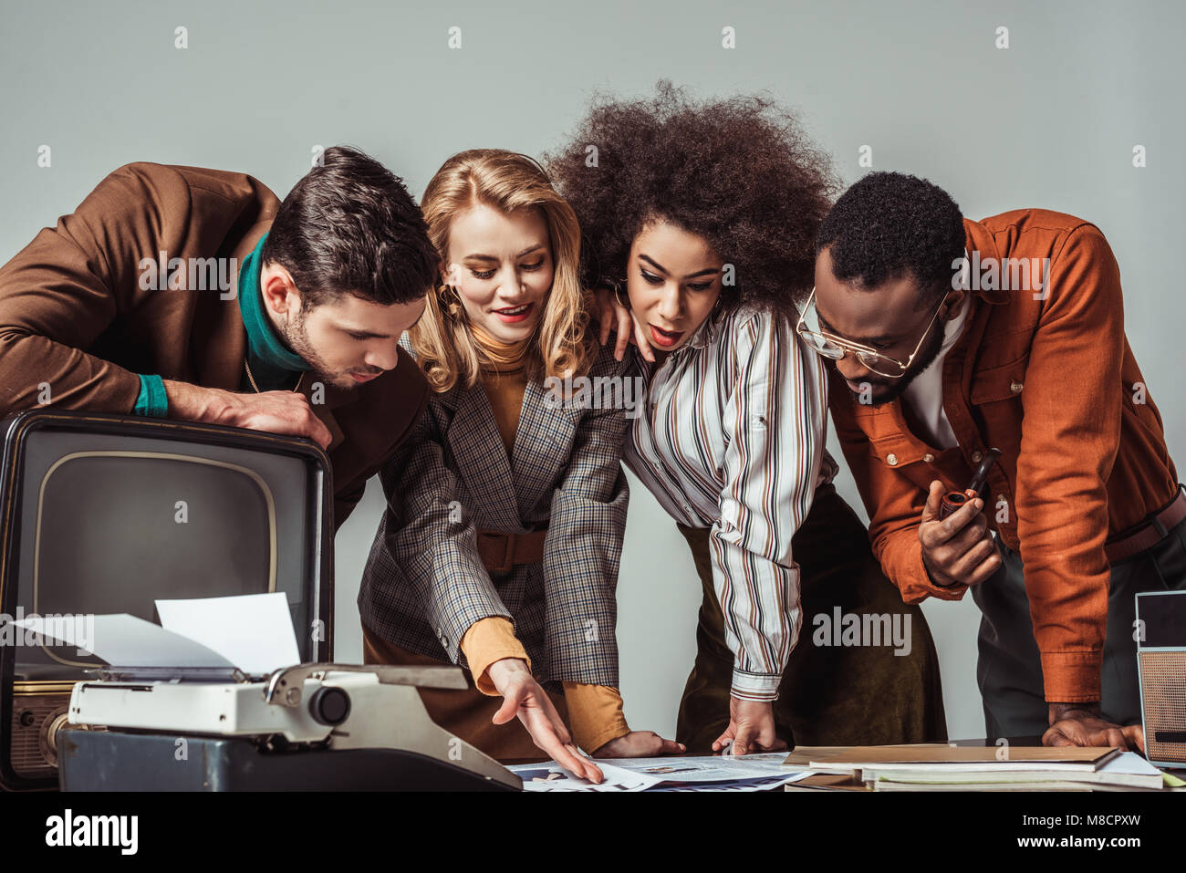 multiethnic retro styled journalists reading newspapers isolated on ...