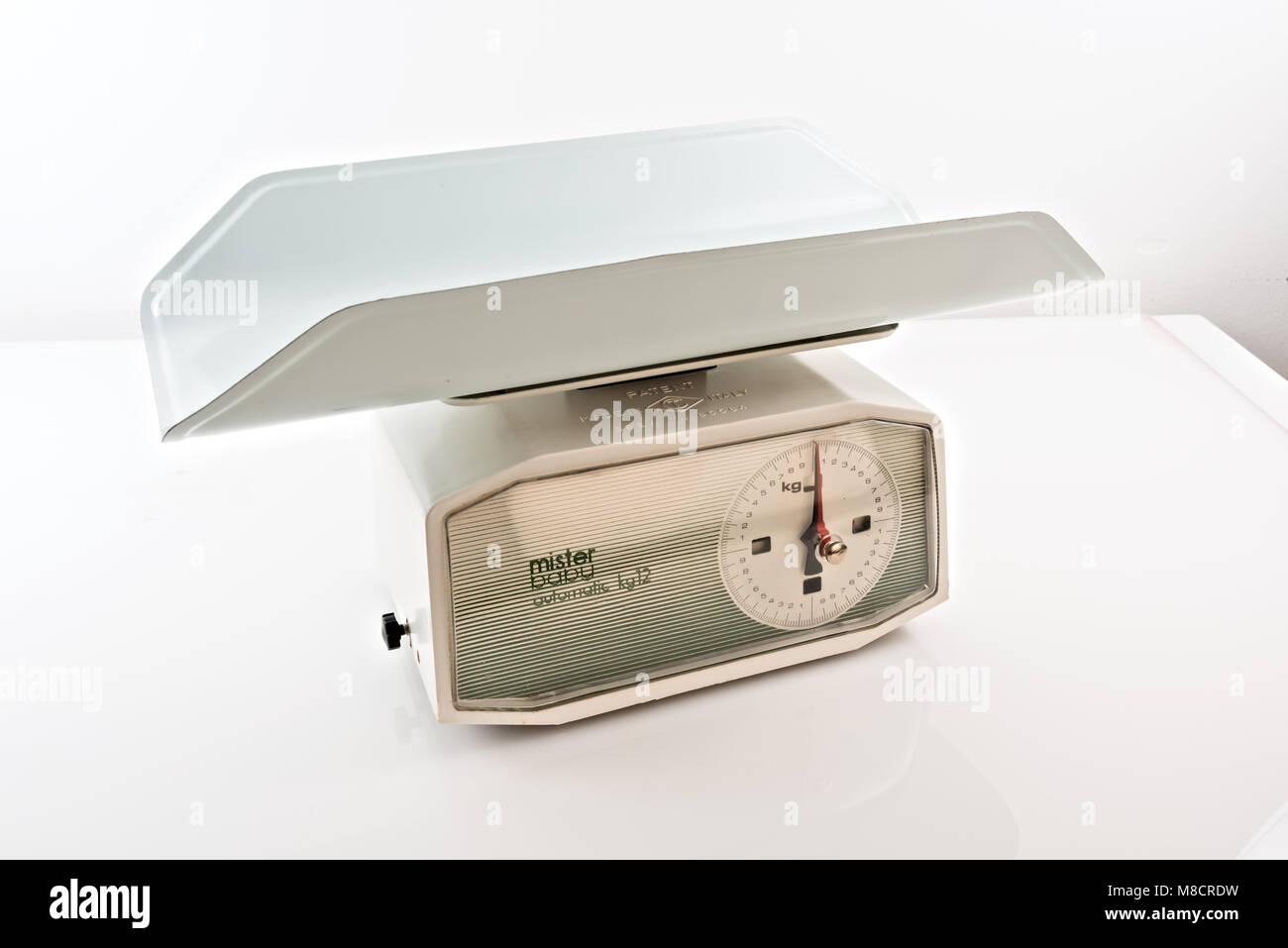 vintage kitchen scales on a white background with a newborn weighing ...