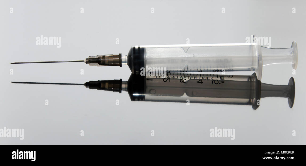 Empty Medical Syringe with a needle on a glossy background Stock Photo ...