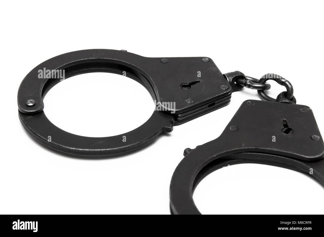 Handcuffs isolated on white clipping path included Stock Photo - Alamy