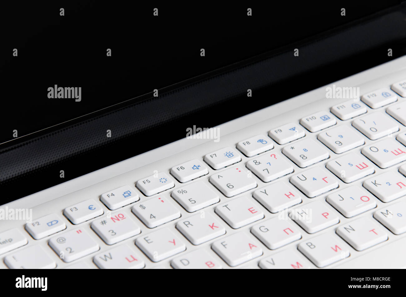 The keyboard and screen of small white laptop Stock Photo - Alamy